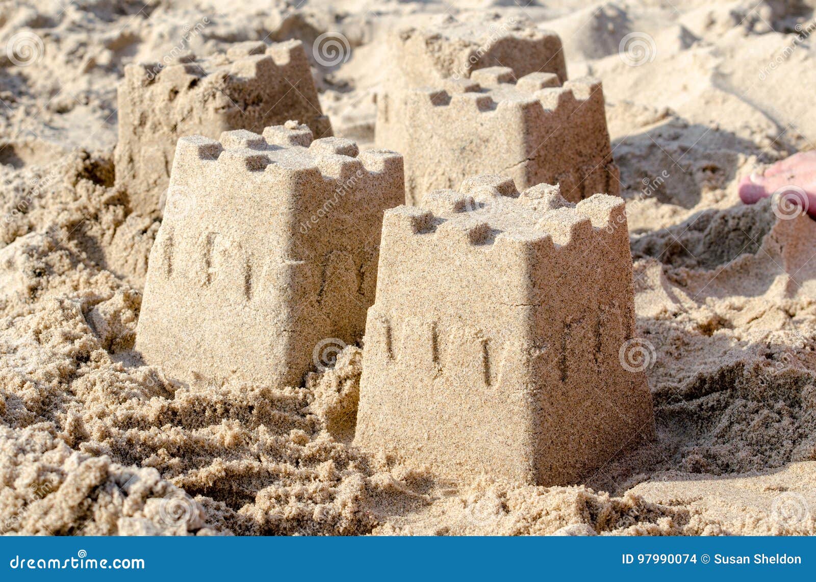 Sand castles on the shore stock photo. Image of build - 97990074