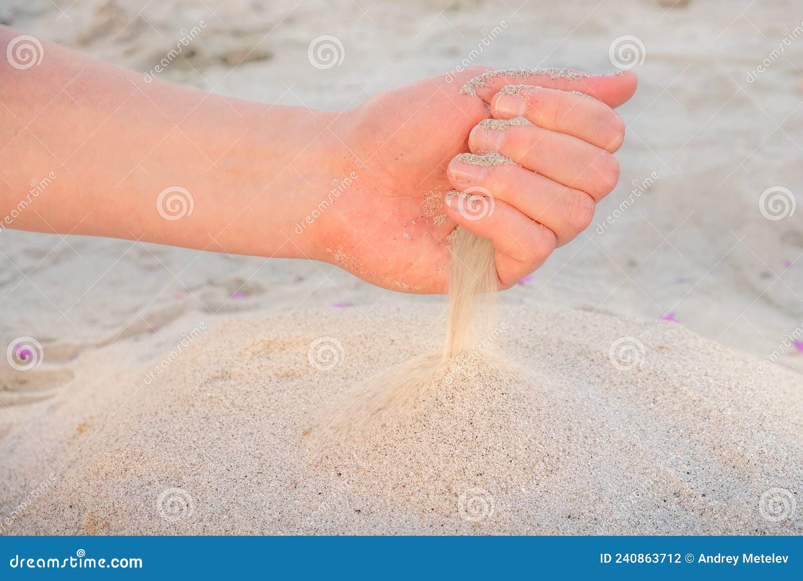 Sand Falls Out of Hand. Pouring Sand on a Sandy Surface Stock Photo ...