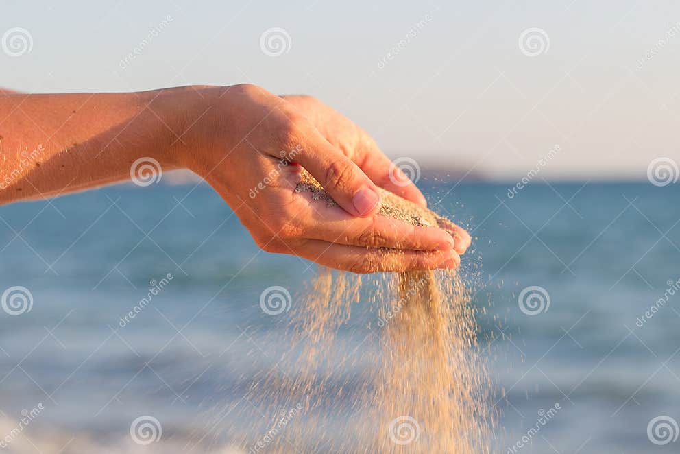 Sand flowing through hands stock photo. Image of wellness - 33521138