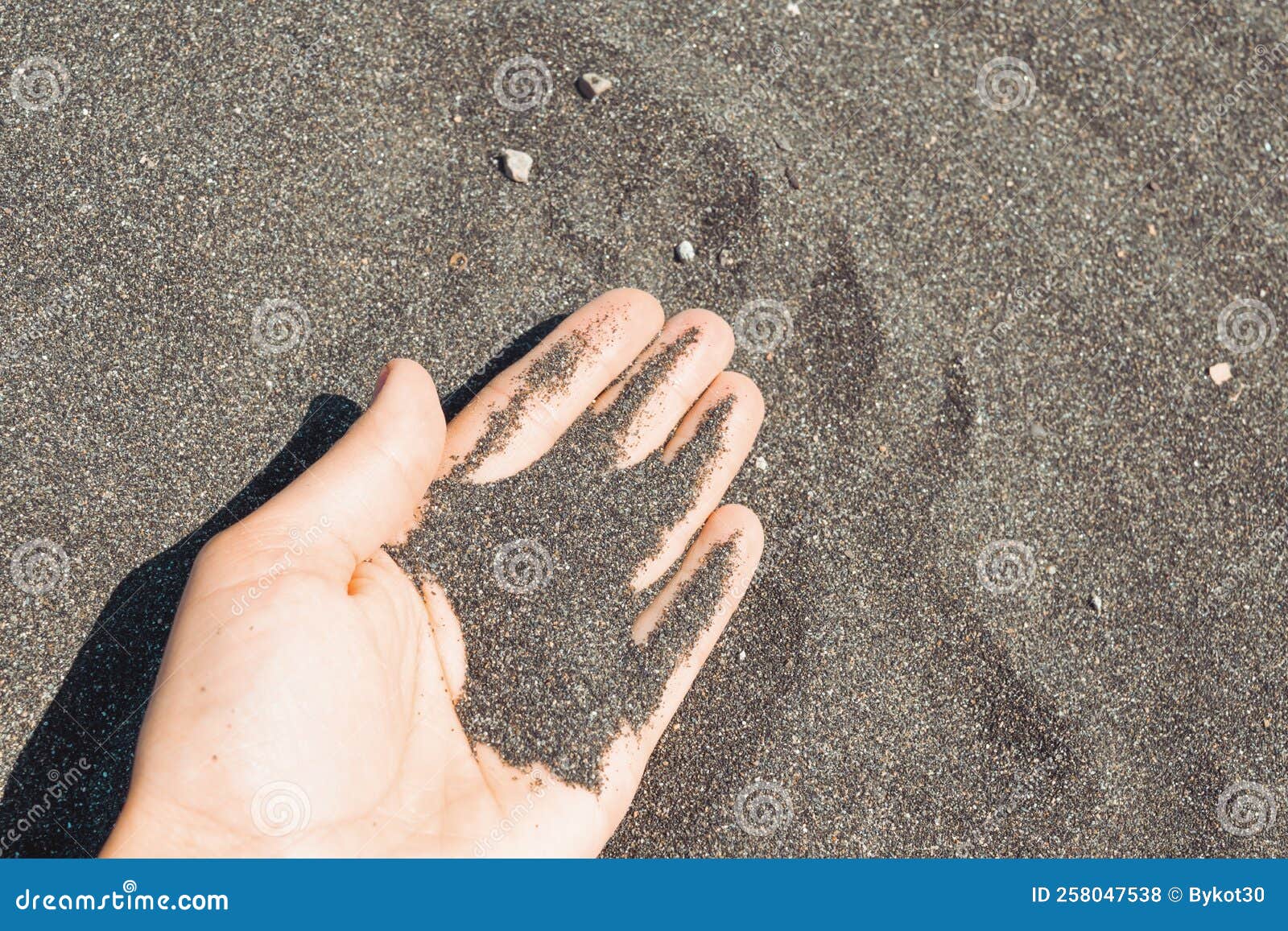 The Man Holds the Sand in His Hand. Black Magnetic Sands. Stock Photo ...