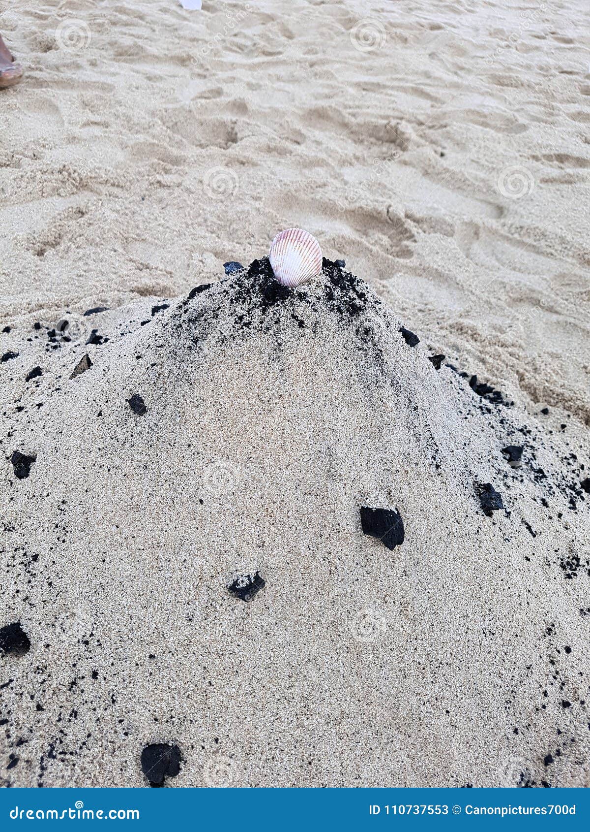 Sand mountain in a beach stock image. Image of coal - 110737553