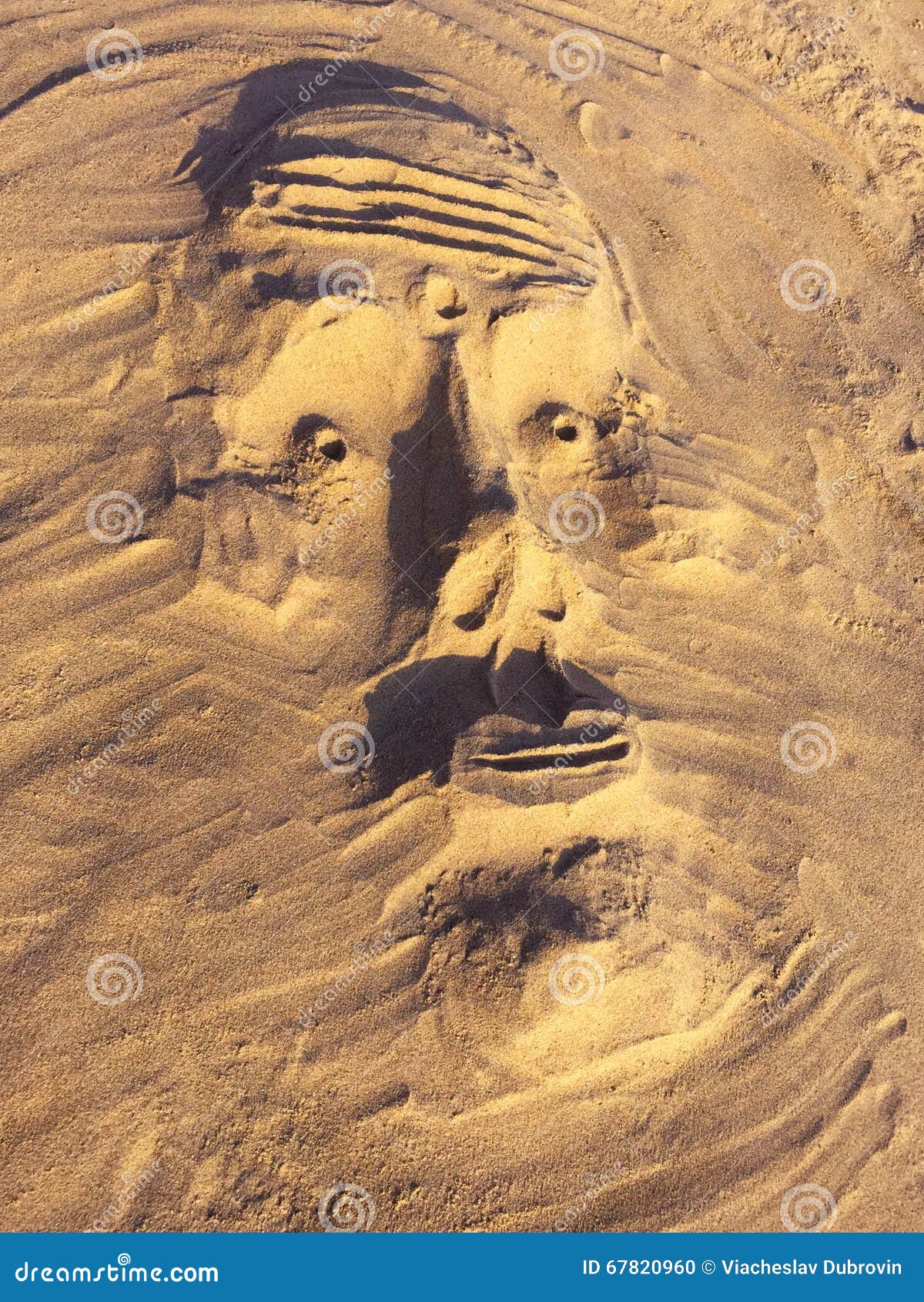 Sand Sculpture Mask on a Beach Stock Photo - Image of yellow, primitive ...