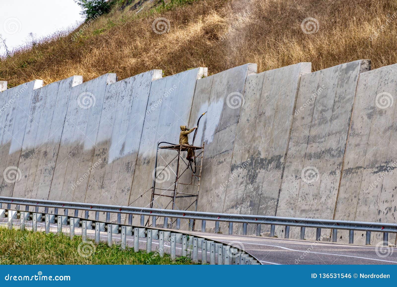Sandblast Cleaning of a Concrete Protective Wall. Stock Photo - Image ...