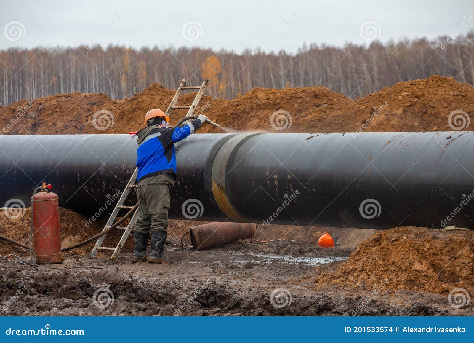 Sandblasting of the Pipeline Weld. a Worker with a Nozzle Processes an ...