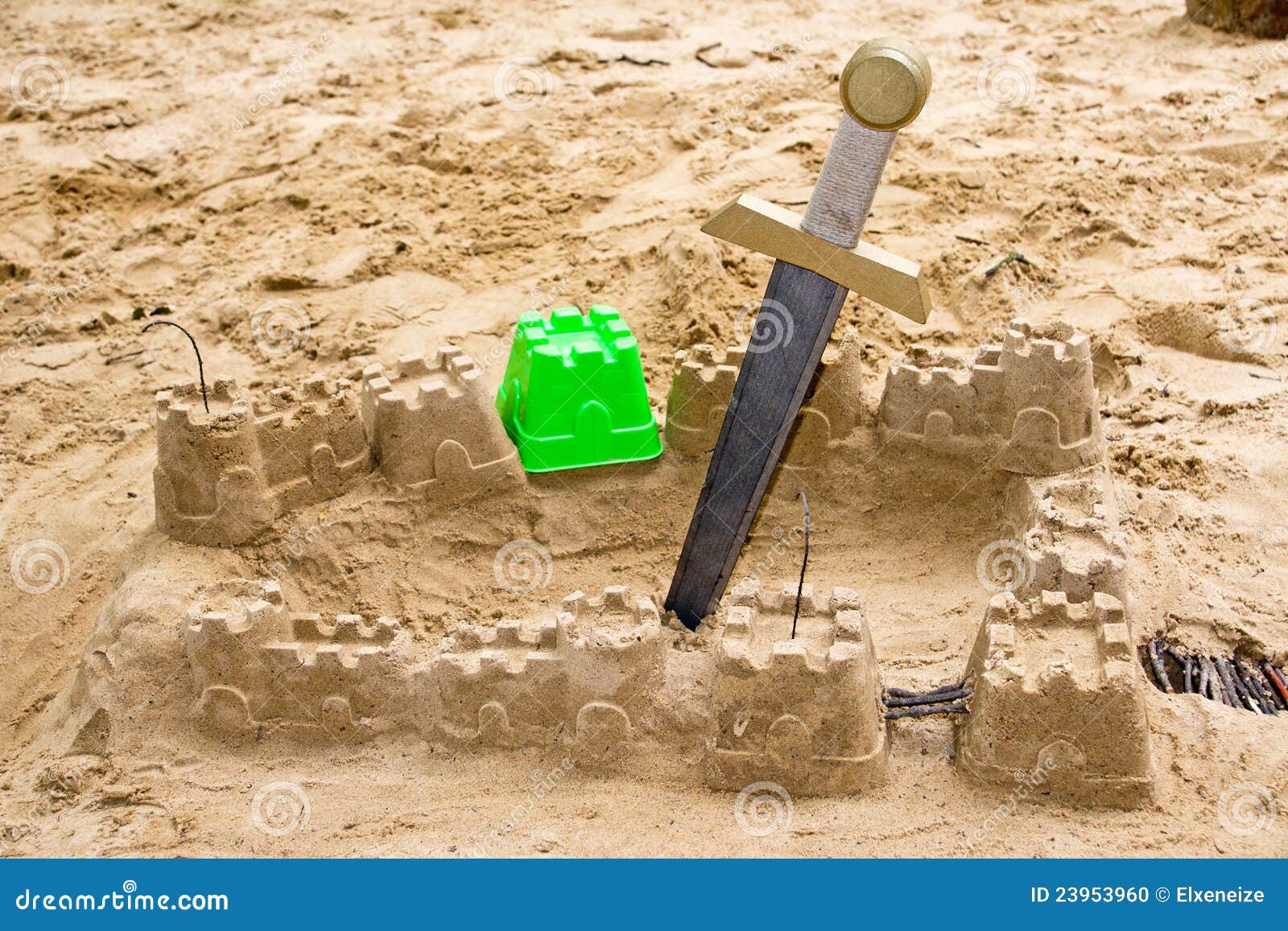 Sandcastle with a sword stock photo. Image of summertime - 23953960