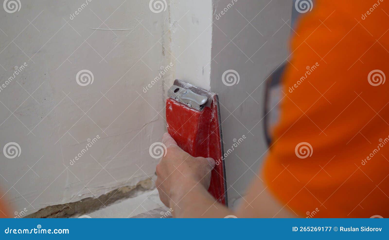 Sanding the Wall after Puttying. the Builder Grinds the Wall from ...