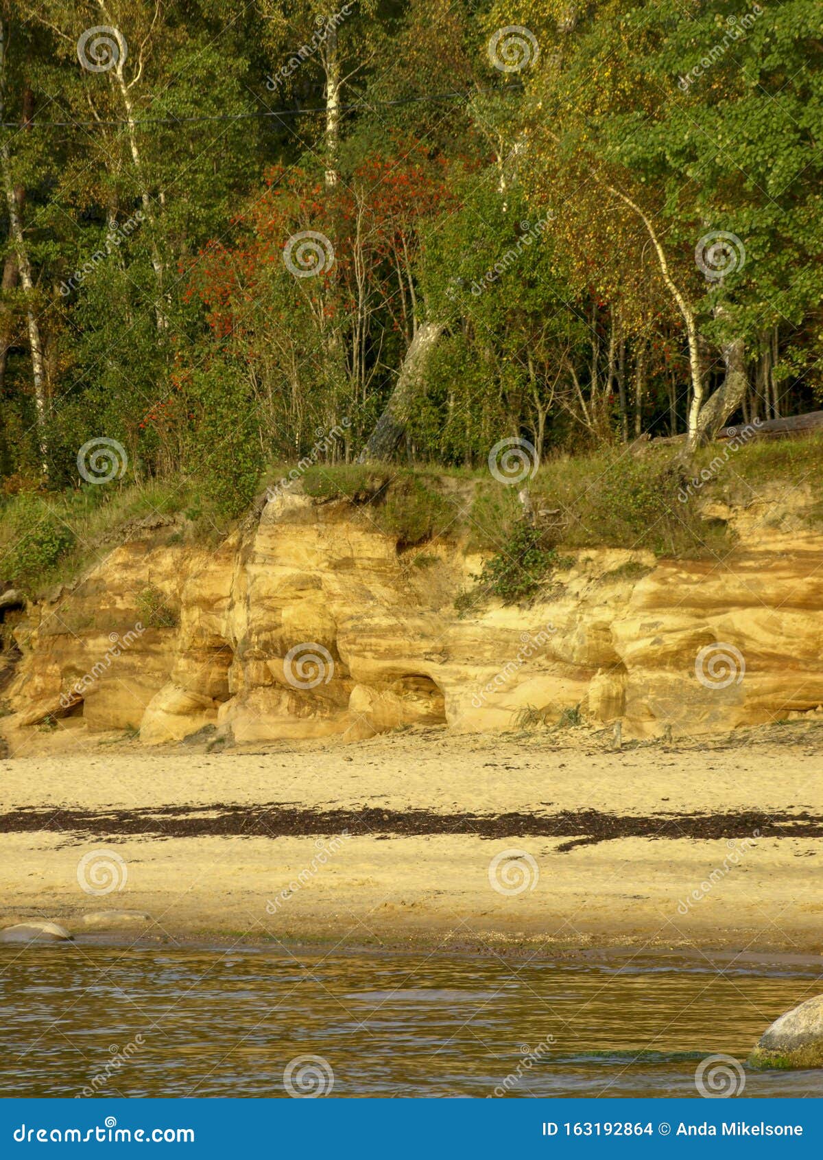 Sandstone Cliffs on the Seashore, Beautiful Reflections in the Water ...
