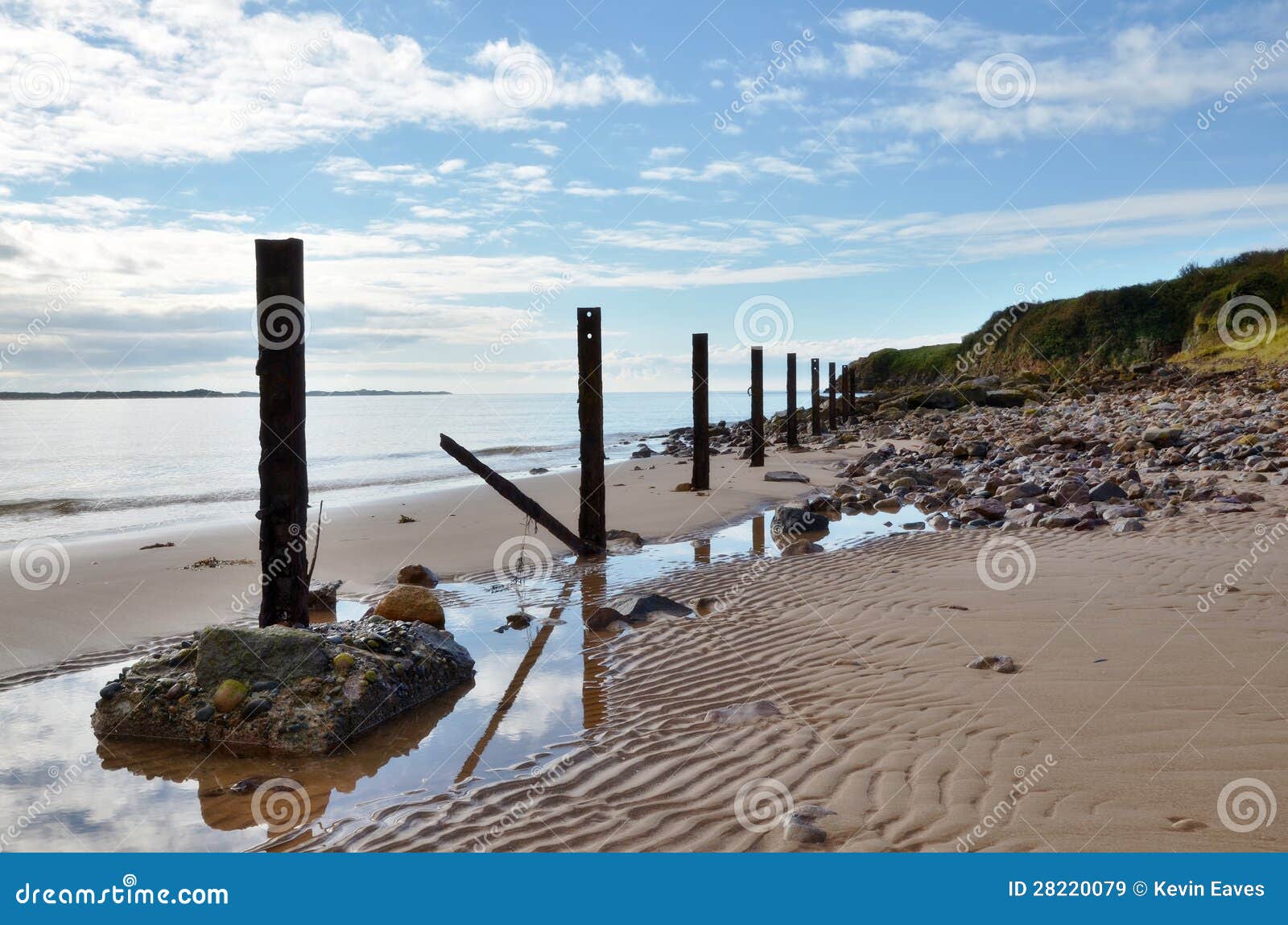 Sandy Beach with a Line of Posts. Stock Image - Image of beach, rocks ...