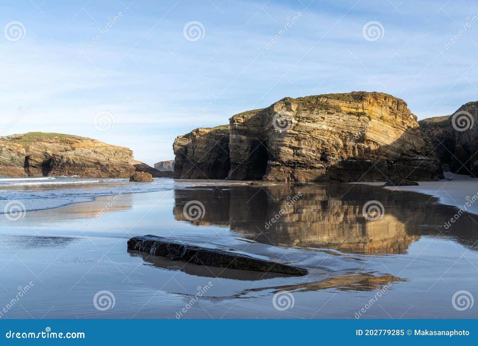 Sandy Beach Panorama with Tidal Pools and Jagged Broken Cliffs Behind ...