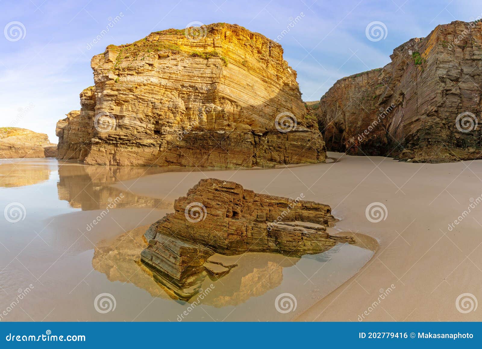 Sandy Beach Panorama with Tidal Pools and Jagged Broken Cliffs Behind ...
