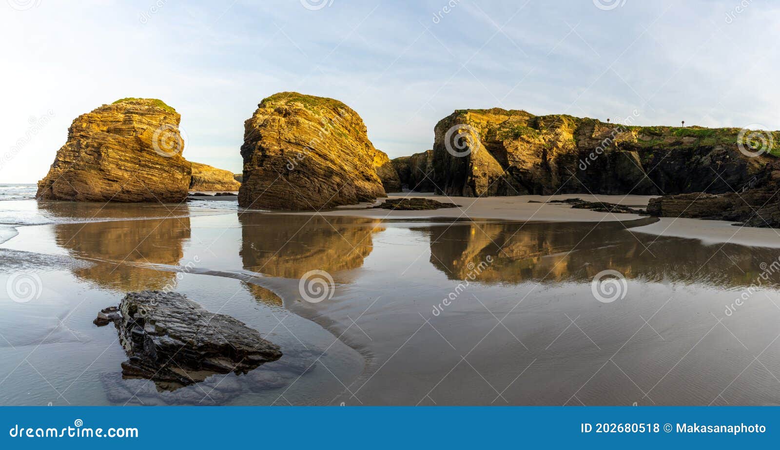Sandy Beach Panorama with Tidal Pools and Jagged Broken Cliffs Behind ...