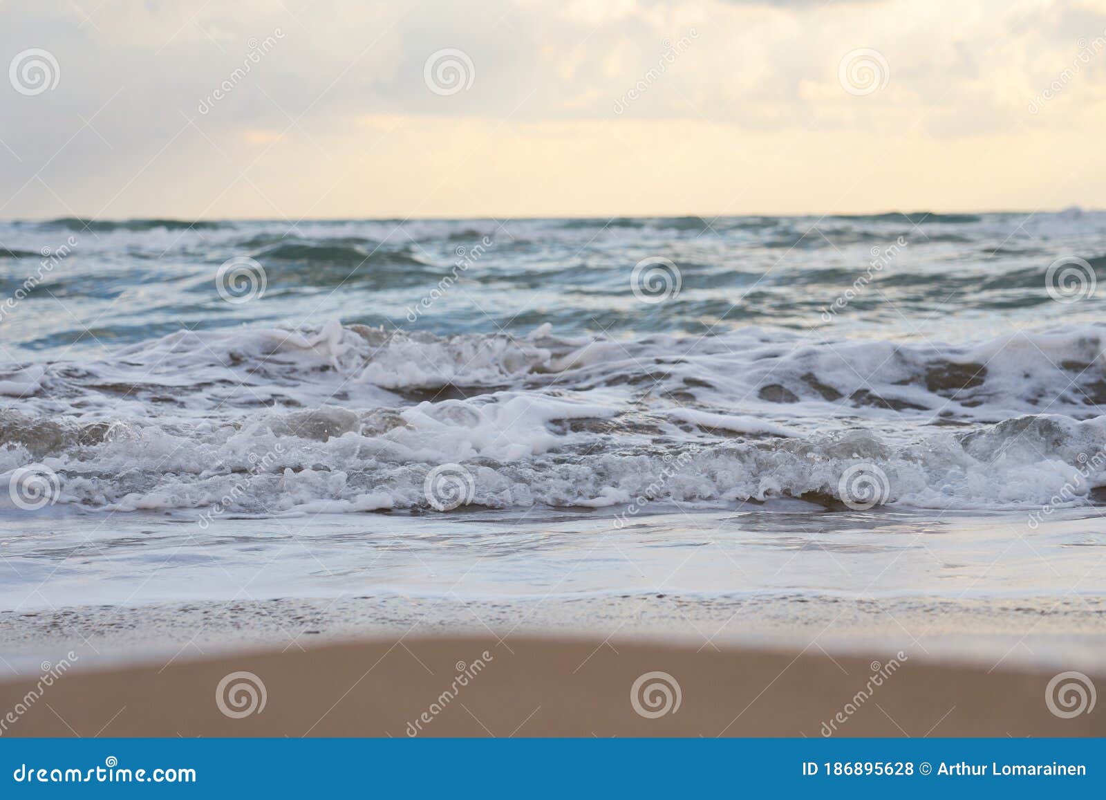 Sandy Beach on a Sunset with Reflection on Wet Sand and Waves with Foam ...