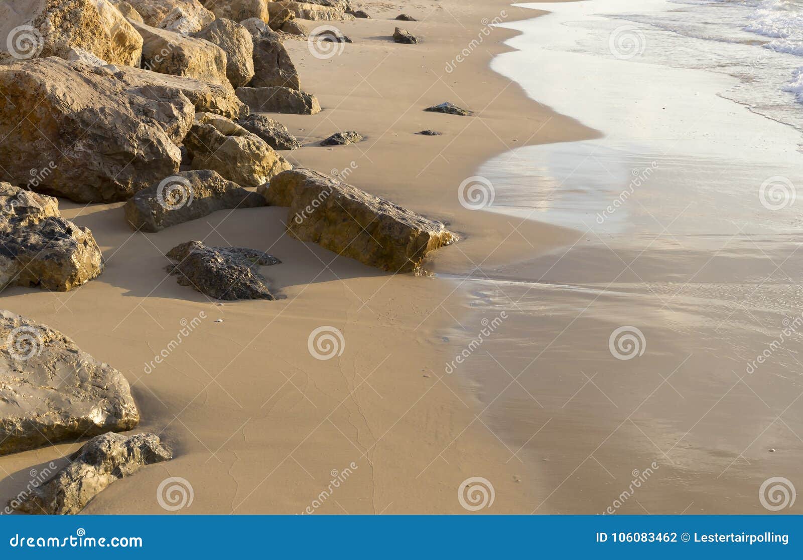 Sandy sea beach with rocks stock photo. Image of shiny - 106083462