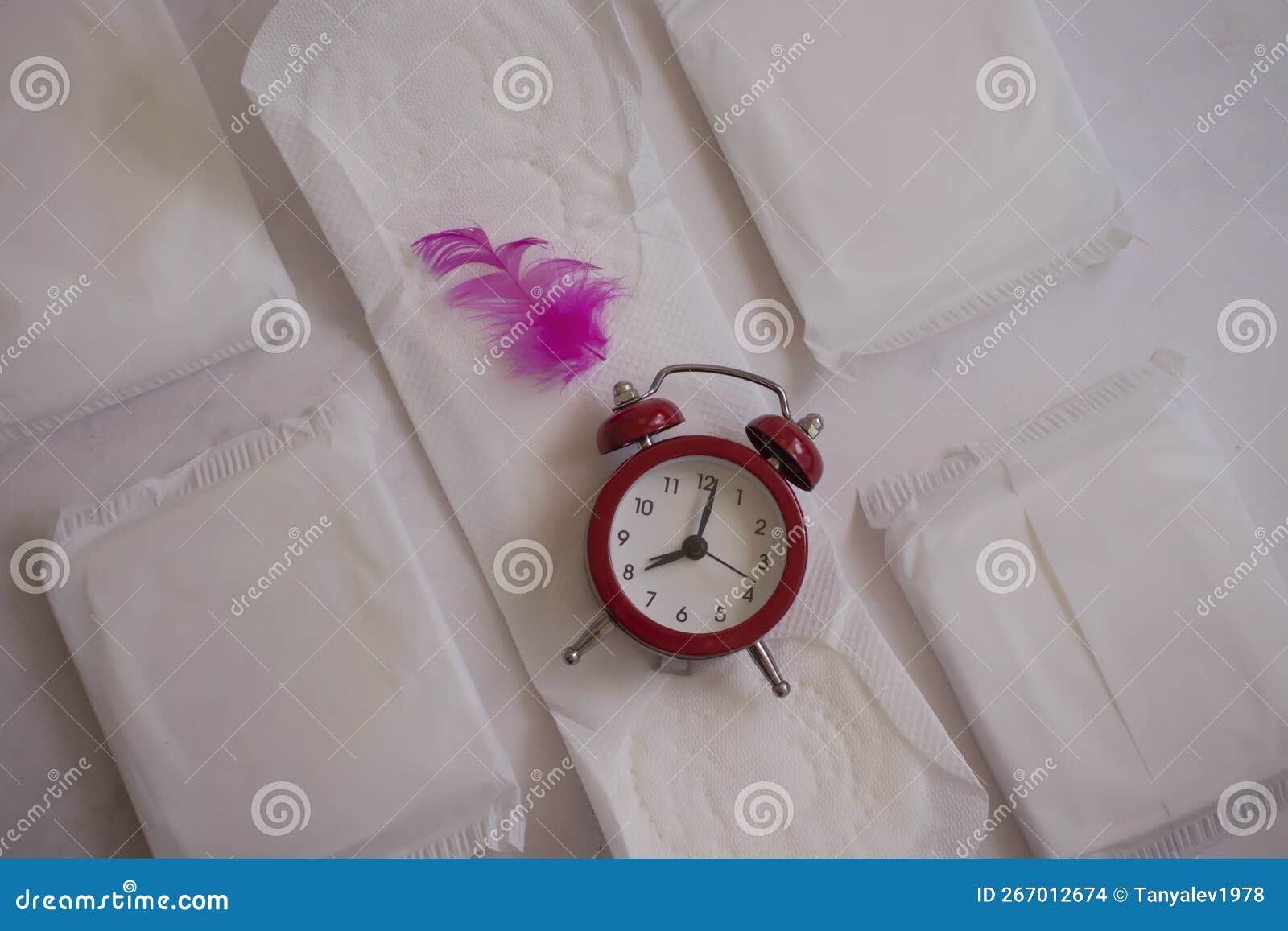 Sanitary Pad, Alarm Clock on a Colored Background Stock Photo - Image ...