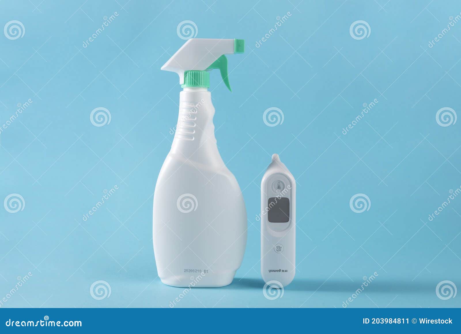 Sanitizing Spray and a Digital Thermometer on a Blue Surface Stock ...