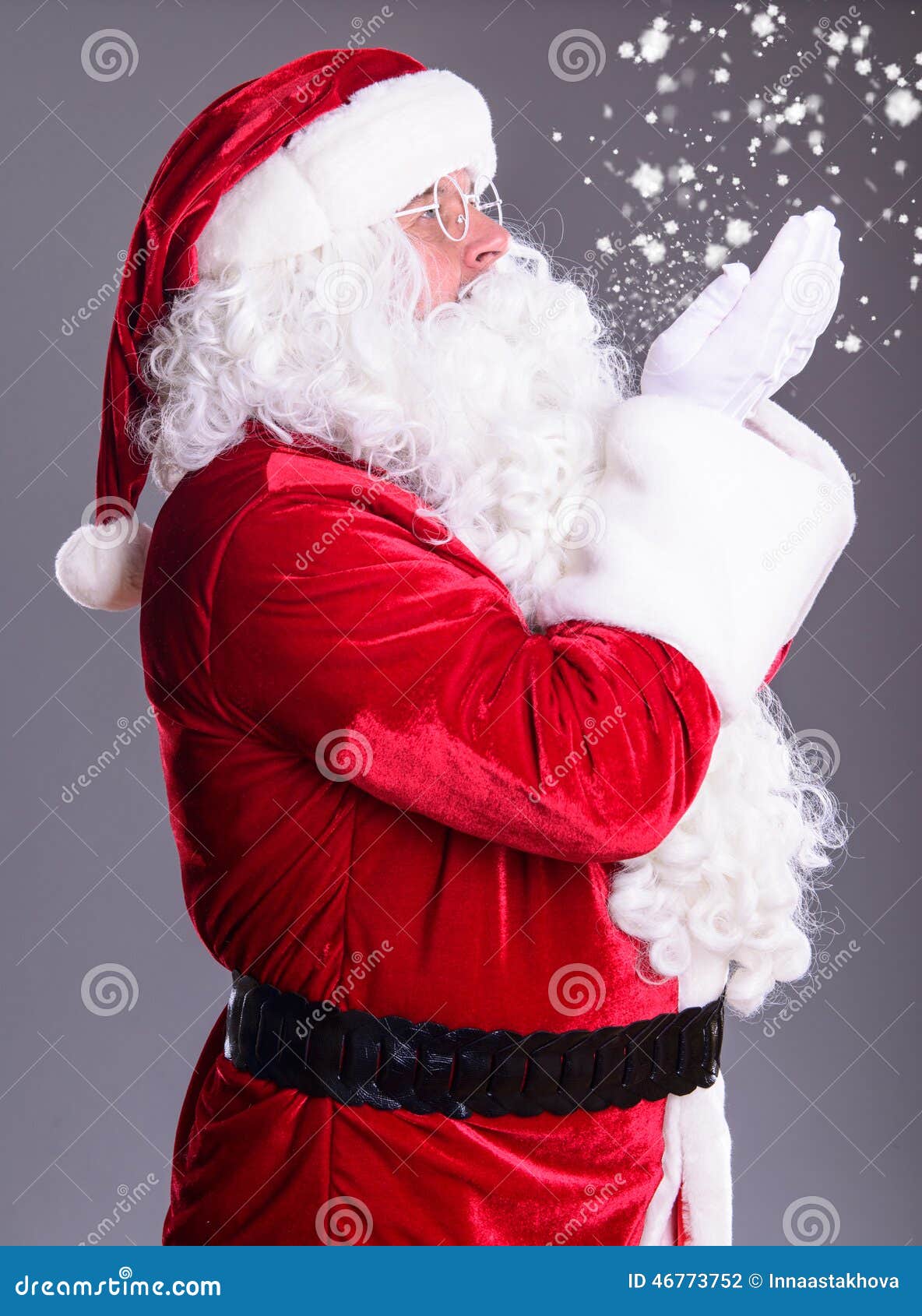 Santa blows off snowflakes stock photo. Image of event - 46773752