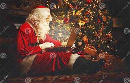 Santa Claus with Computer before Christmas Stock Photo - Image of ...