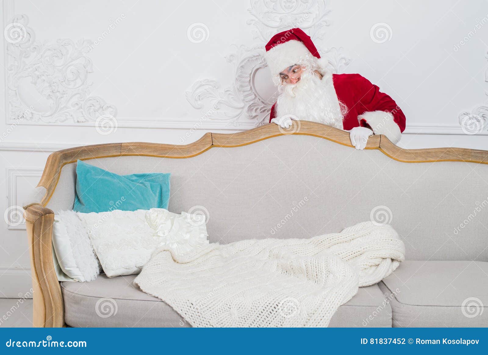 Santa Claus Hiding Behind a Sofa Over Home Interior Stock Photo - Image ...