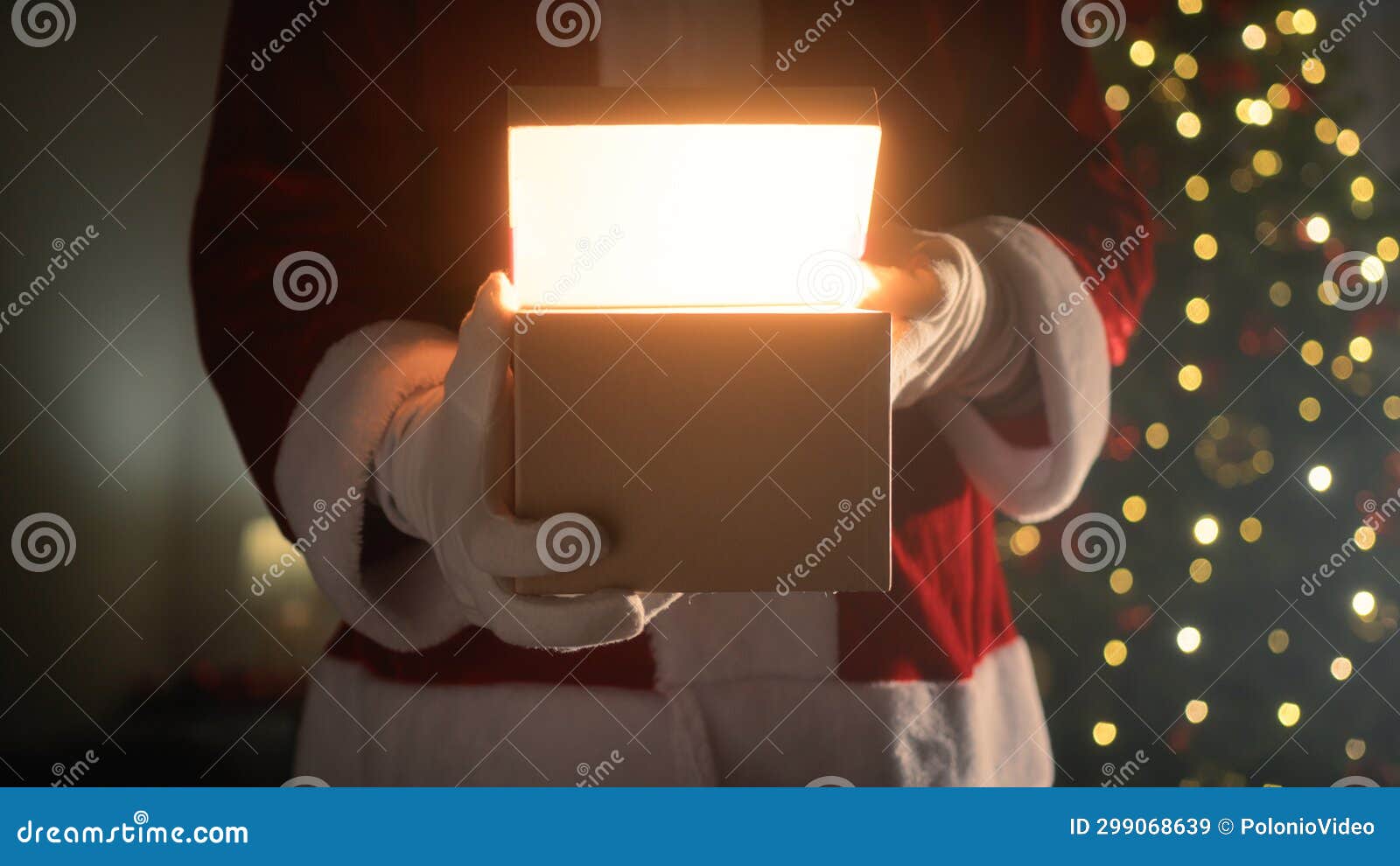 Santa Claus Opening a Present with Bright Light Inside Stock Image ...