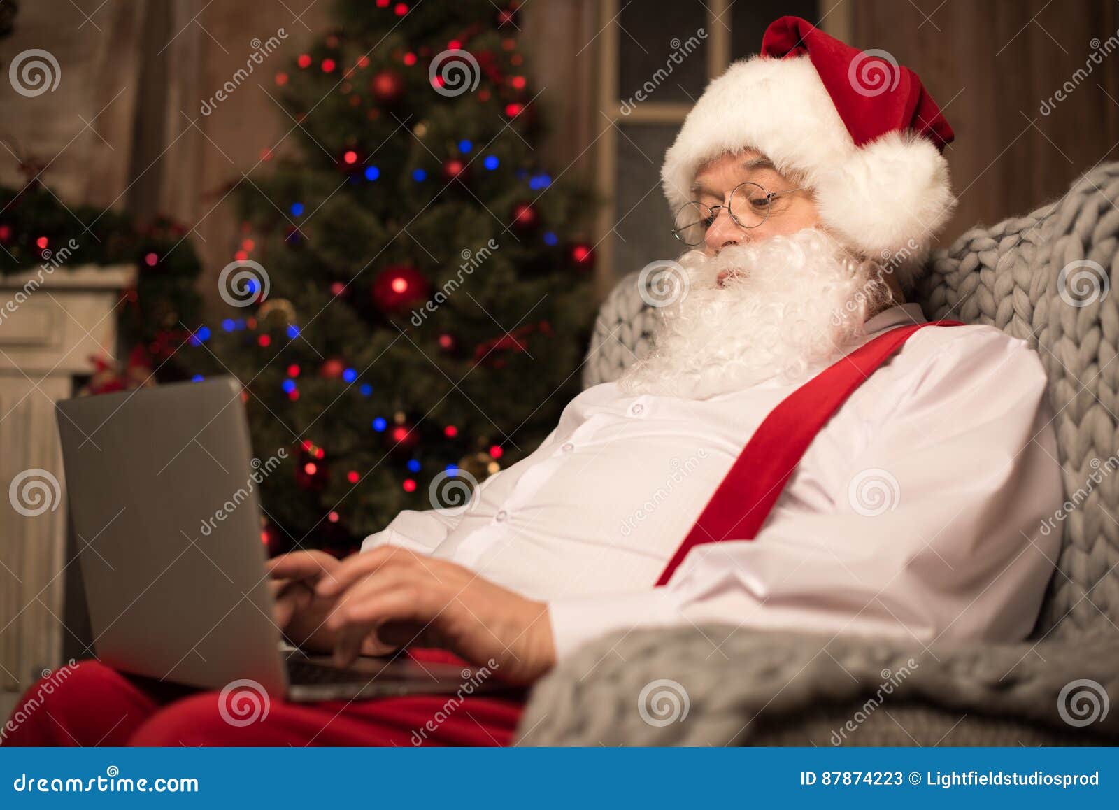 Santa Claus using laptop stock image. Image of grey, gifts - 87874223