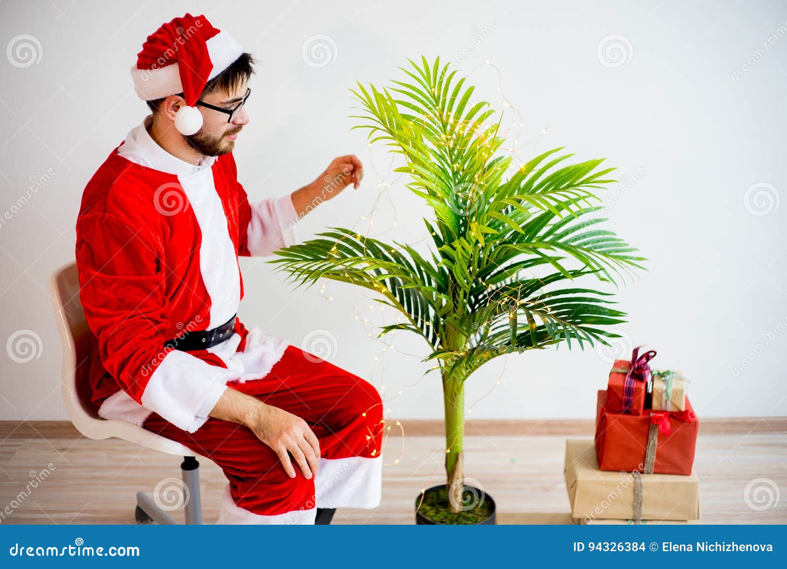 Santa decorating a tree stock photo. Image of person - 94326384
