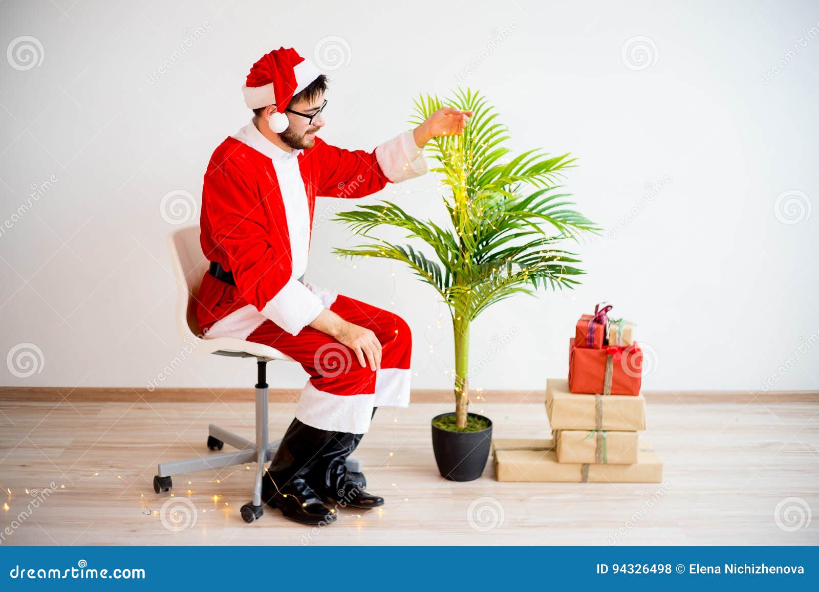Santa decorating a tree stock photo. Image of carnival - 94326498