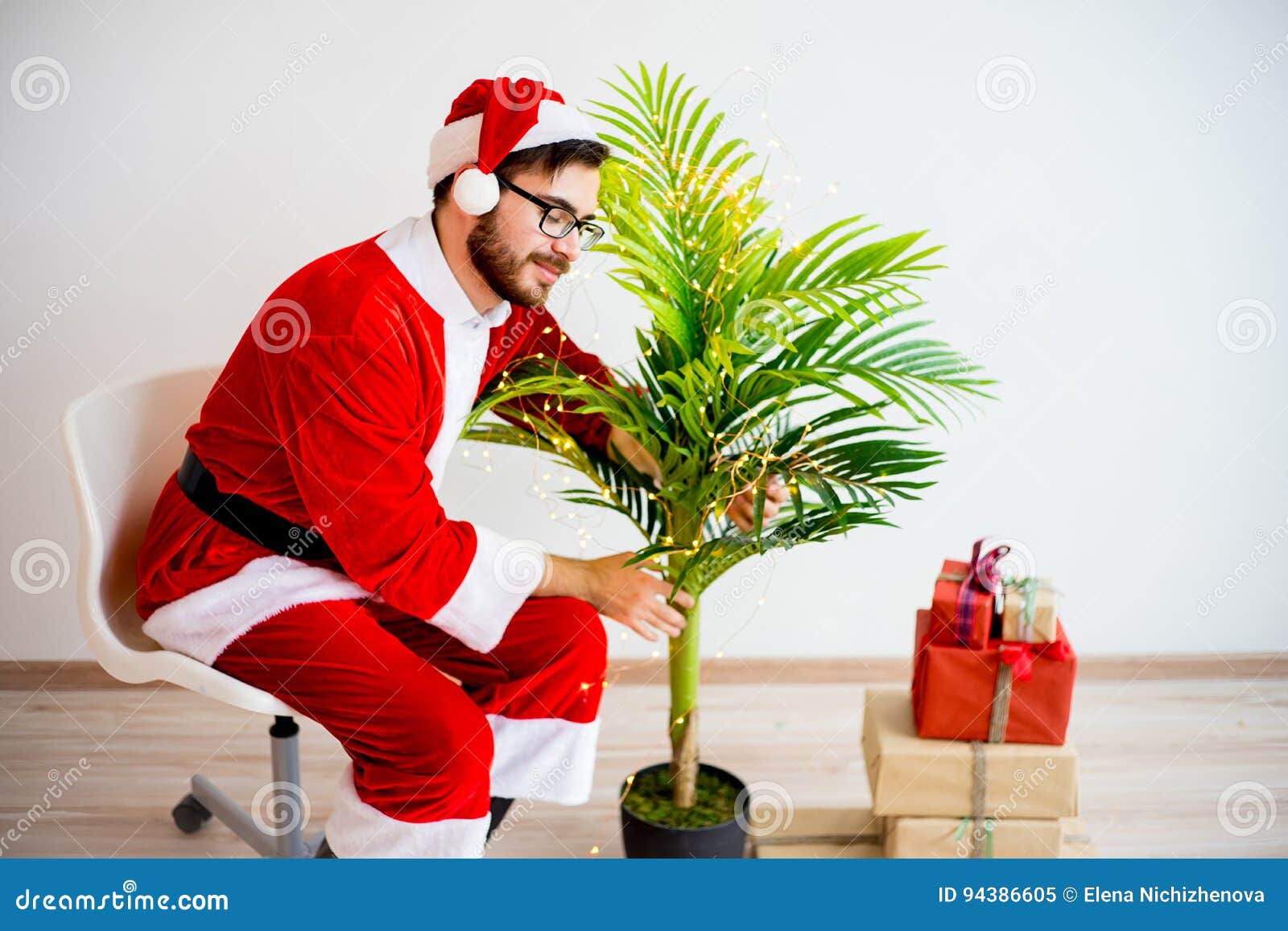 Santa decorating a tree stock image. Image of model, celebration - 94386605