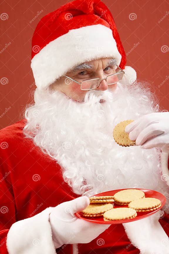 Santa eating stock image. Image of elderly, holds, people - 16437753