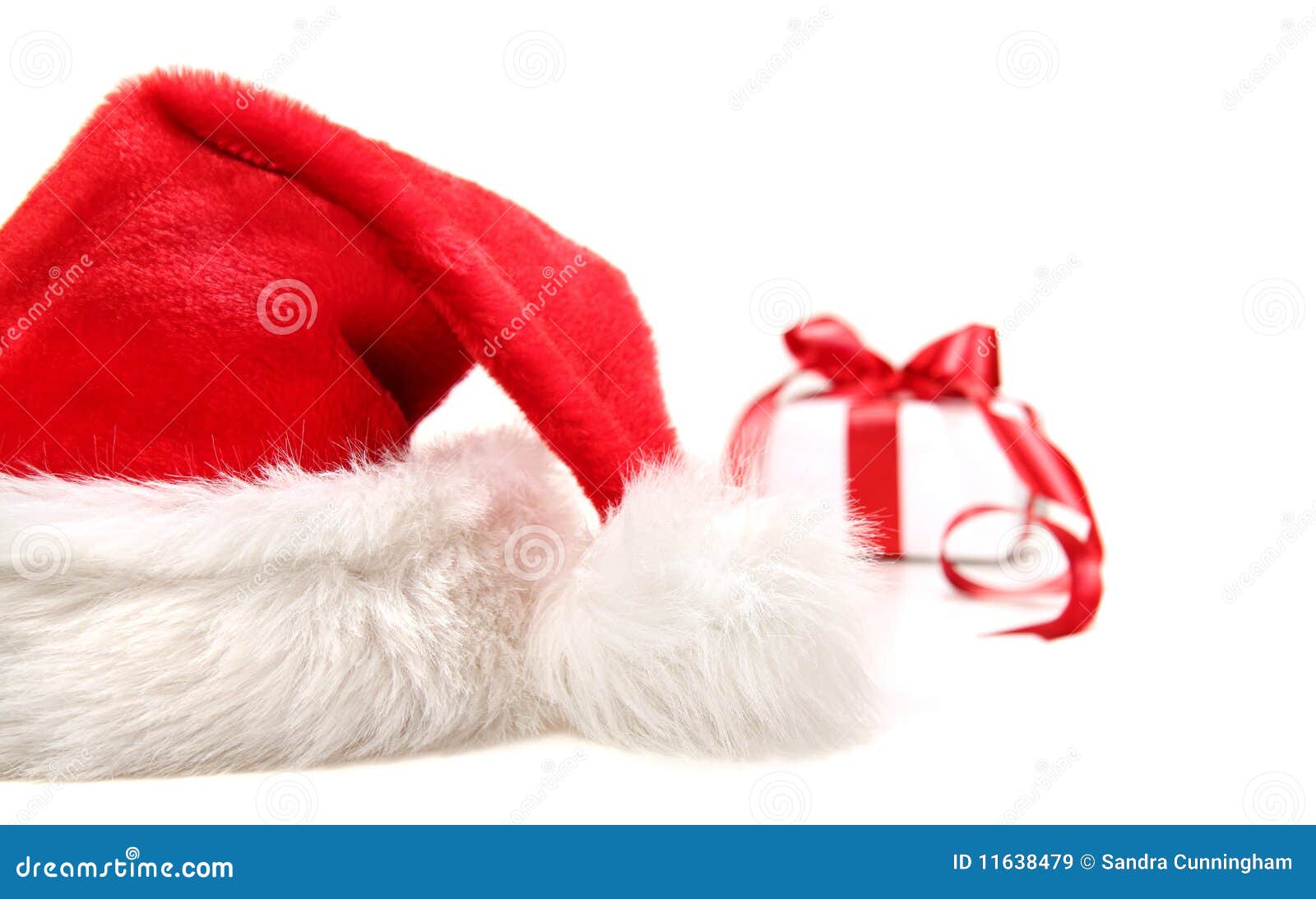 Santa Hat and Gift with Red Bow Stock Image - Image of isolated, santa ...