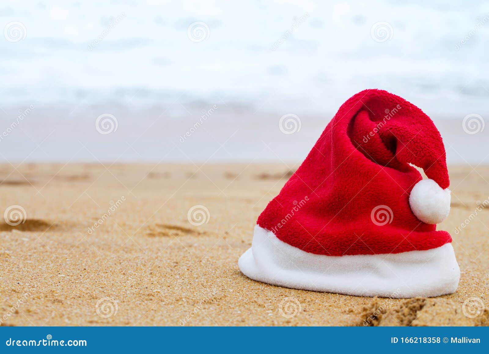 Santa hat by the ocean stock photo. Image of seaside - 166218358