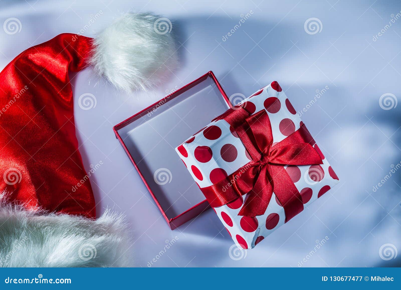 Santa Hat Wrapped Gift Box on White Surface Stock Image - Image of ...