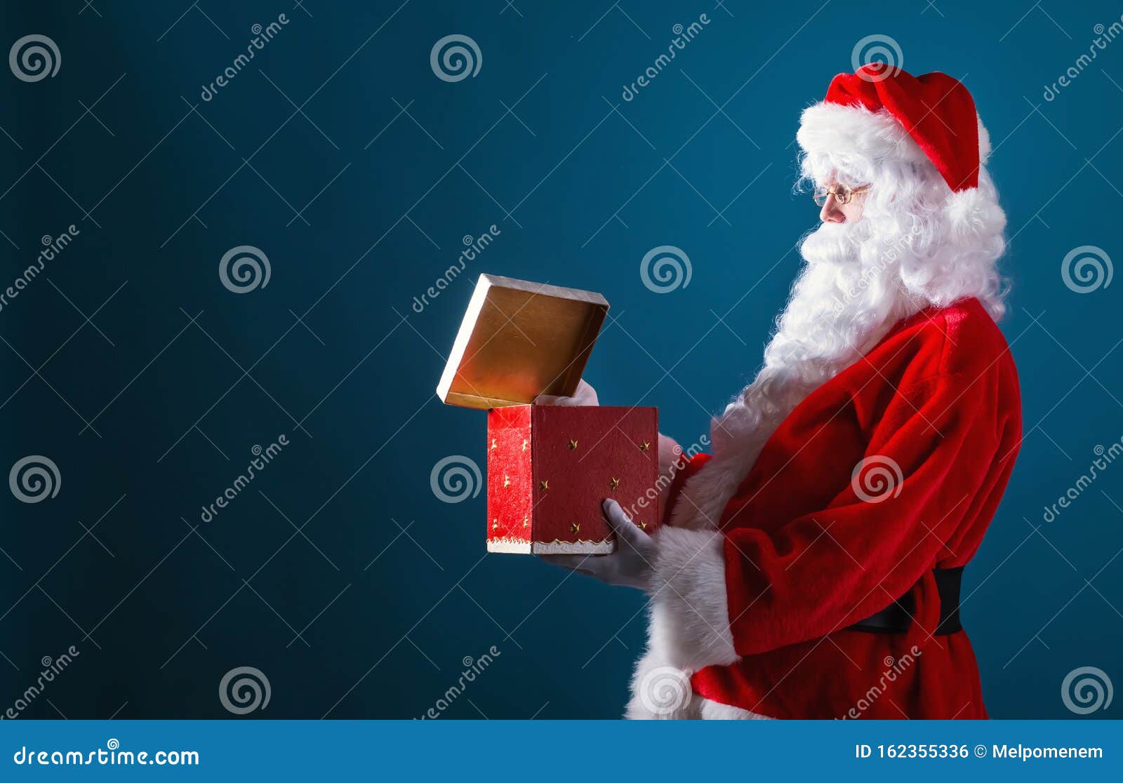 Santa opening a gift box stock photo. Image of color - 162355336