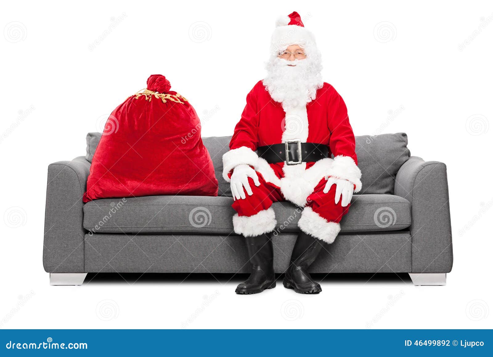 Santa Sitting on a Sofa with Bag of Presents Stock Photo - Image of ...