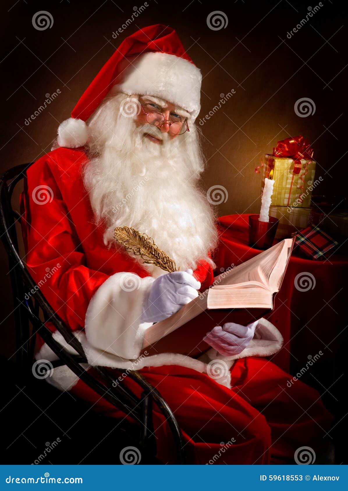 Santa Writes a Magic Feather in the Book Stock Image - Image of ...