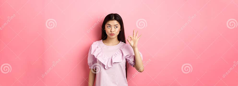 Sassy Asian Woman In Dress Show Okay Sign Looking Aside Assure