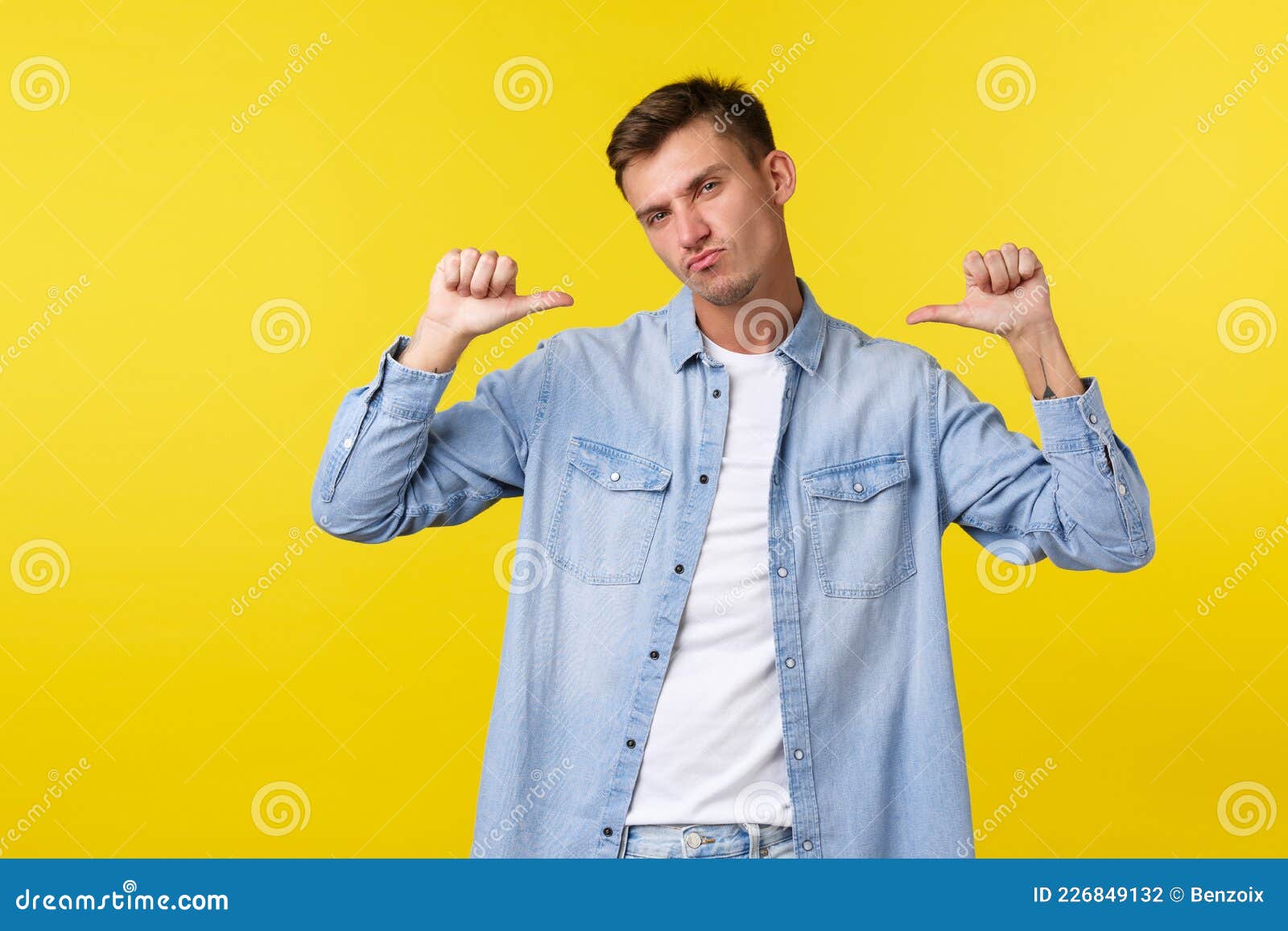 Sassy And Cool Handsome Blond Guy Pointing At Himself And Grimacing Acting Strong And Proud