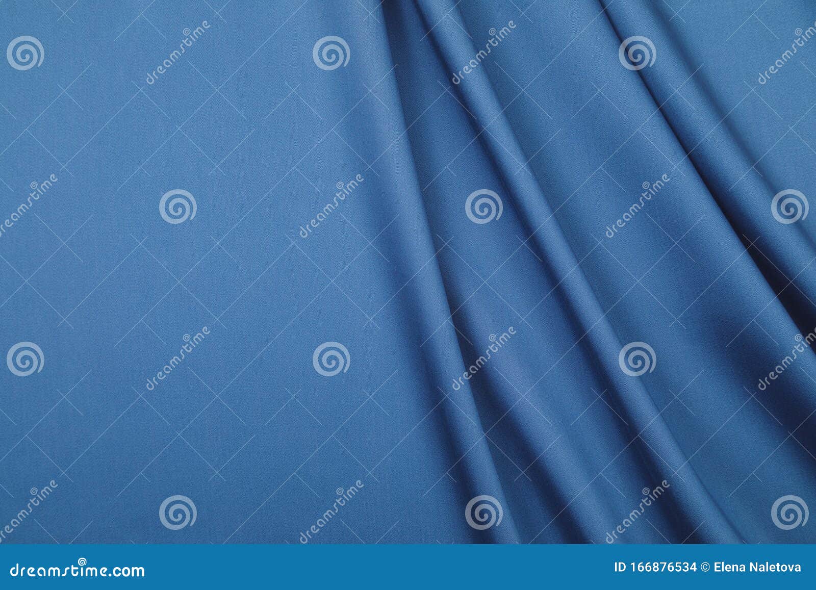 The Sateen Cut of Blue Fabric is Spread Out by the Soft Draped Folds ...