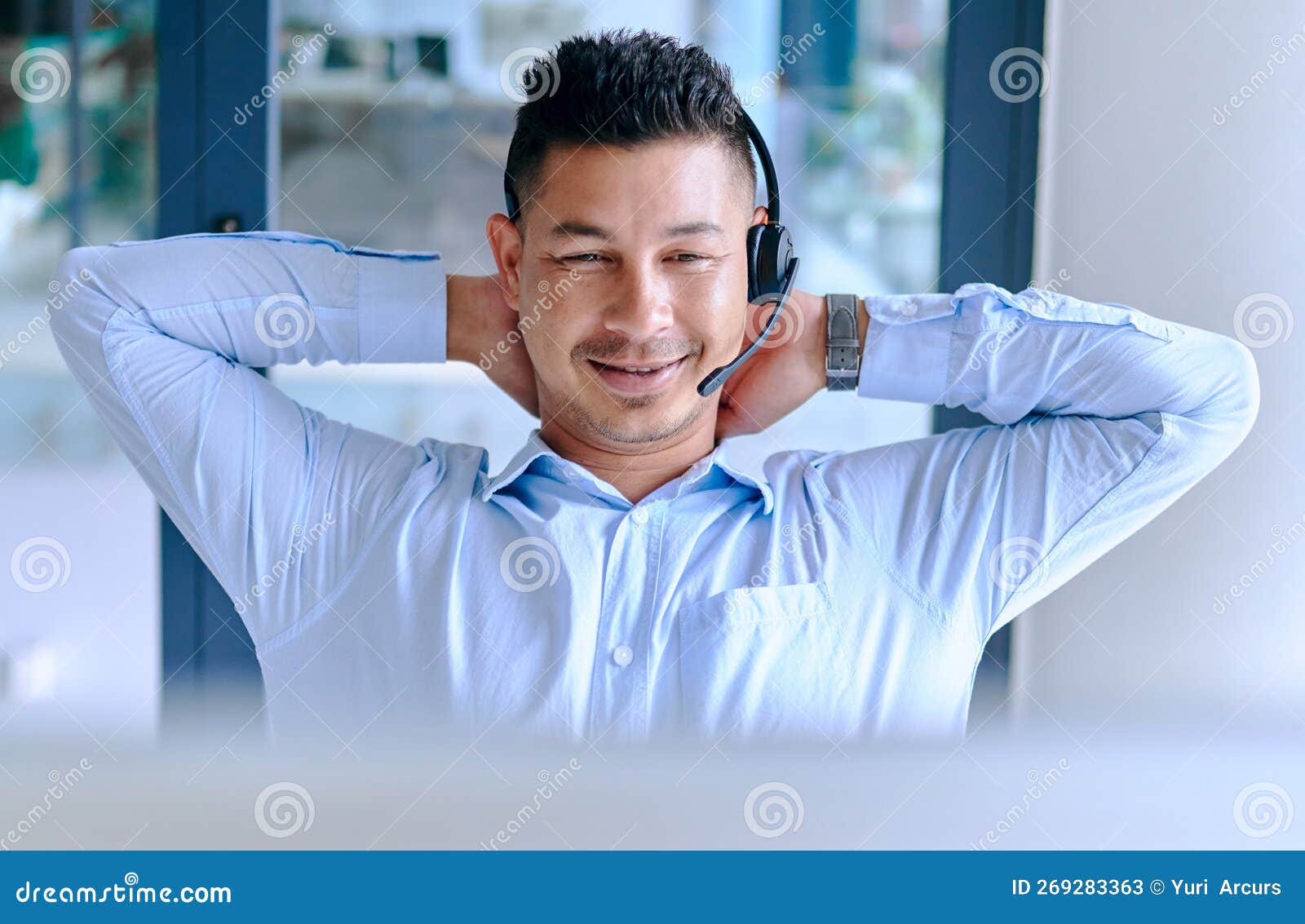 Satisfied Client, Satisfied Agent. a Young Man Using a Headset and ...
