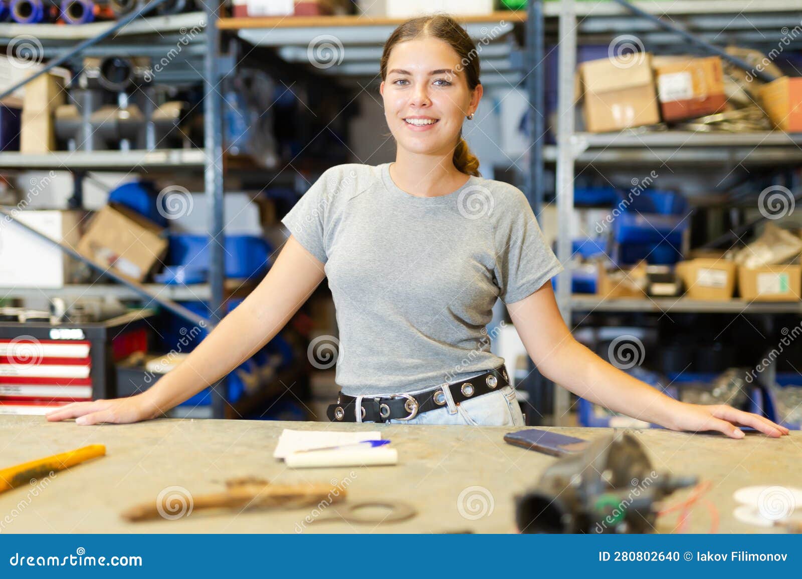 Satisfied Female Employee of Hardware Store Posing in Warehouse Stock ...