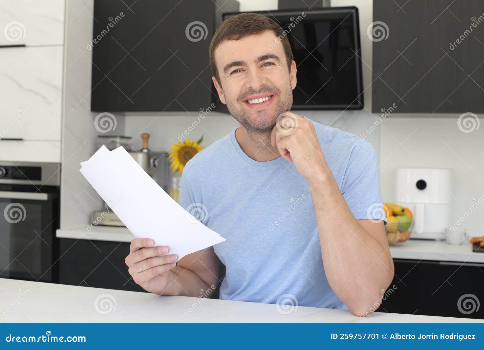 Satisfied Man Looking at Some Documents in the Kitchen Stock Image ...
