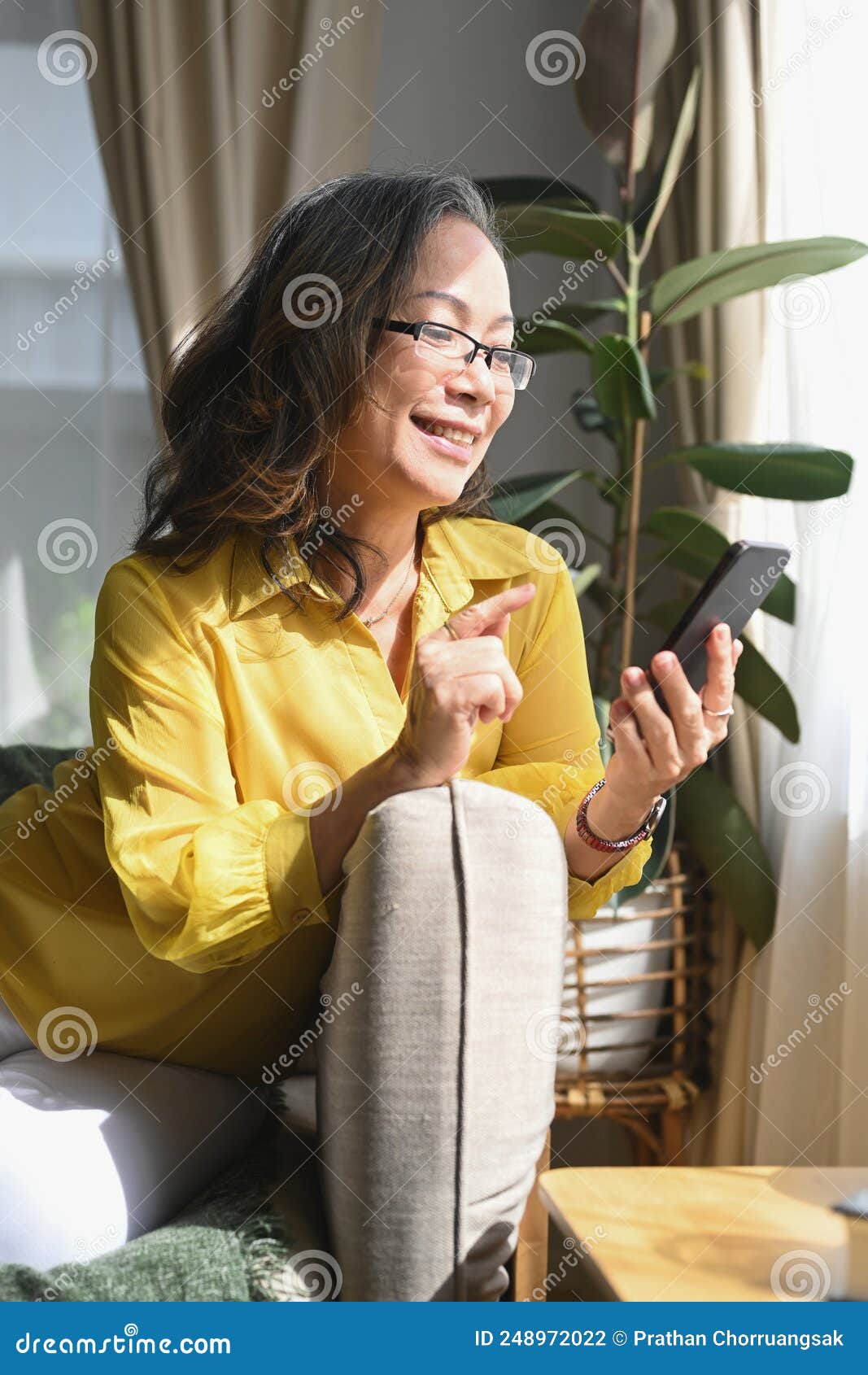 Satisfied Middle Aged Using Smart Phone on Comfortable Sofa at Home ...