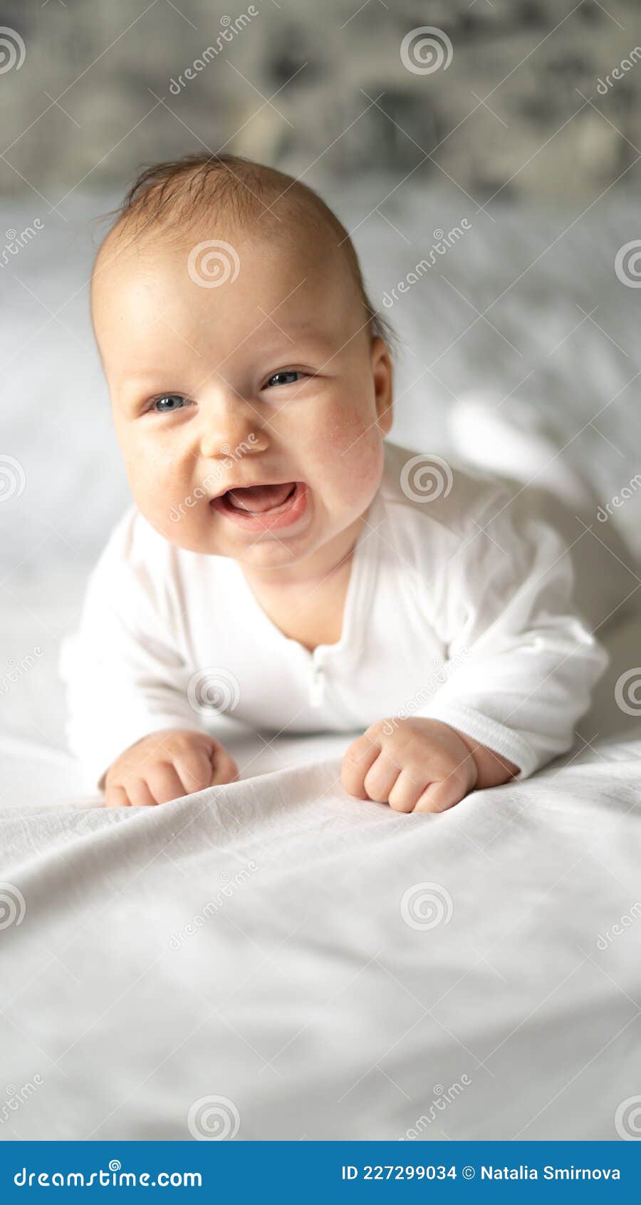 Satisfied Smiling Baby Lying On His Stomach On A White Background ...