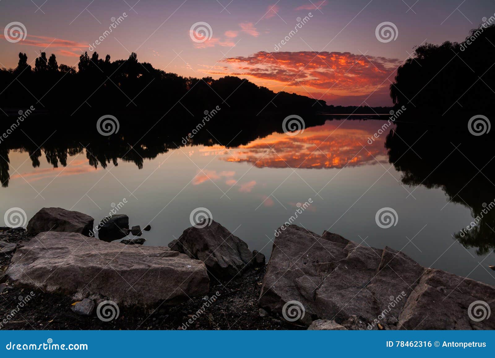 Saturated Red Sunrise Over Lake Stock Photo - Image of overcast, mirror ...