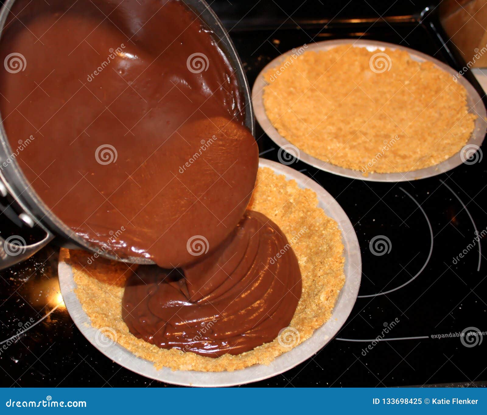 Pouring Chocolate into Pie Pan Filled with Graham Cracker Crust Stock ...