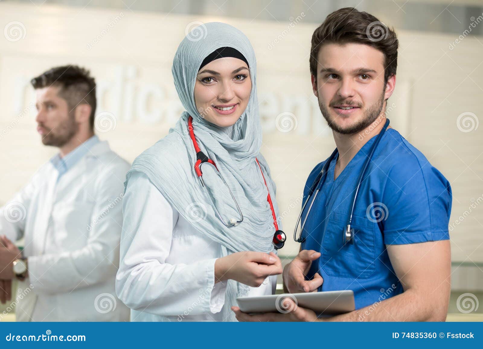 Saudi Arab Doctors Working with a Tablet. Stock Photo - Image of ...