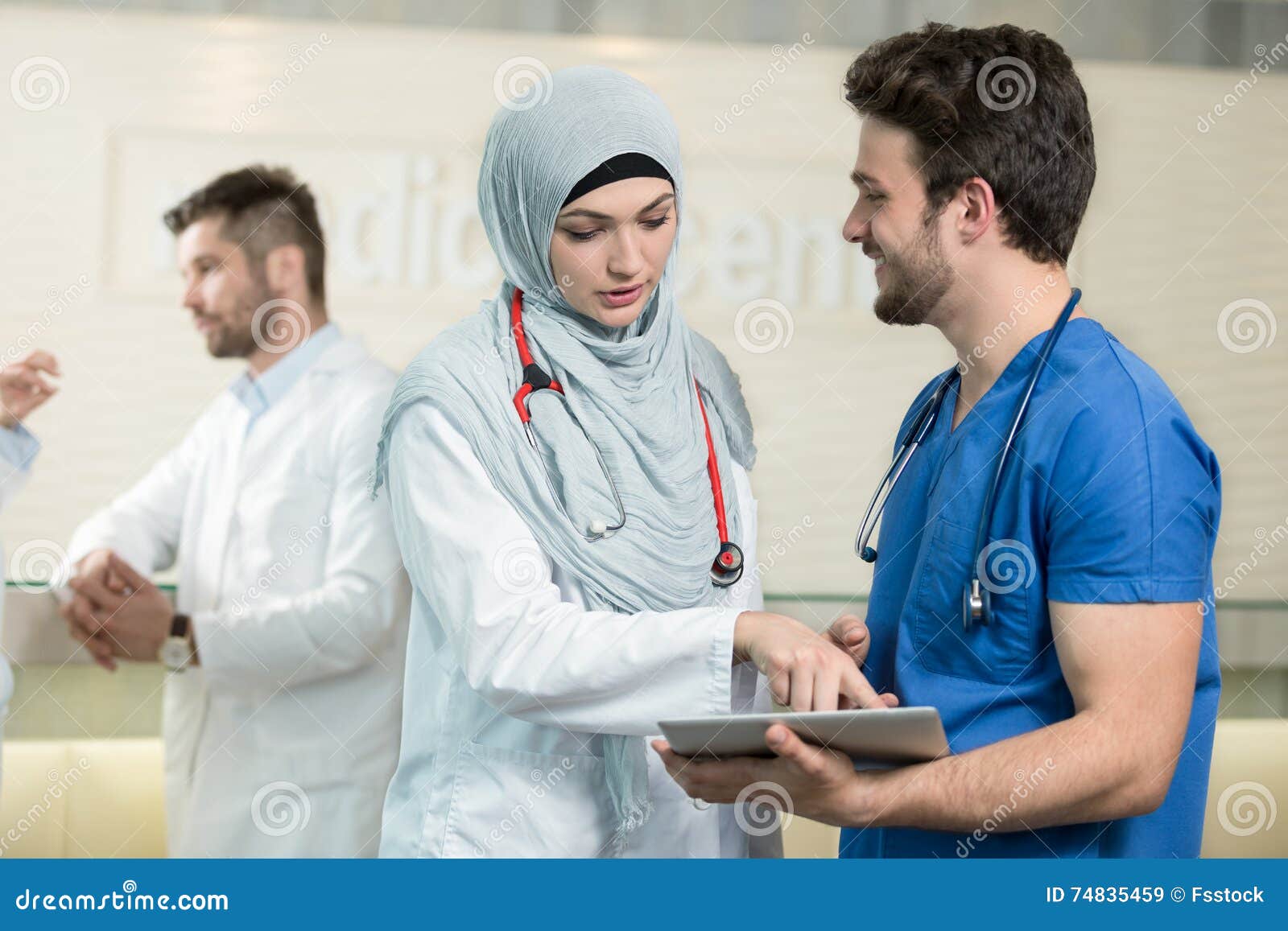 Saudi Arab Doctors Working with a Tablet. Stock Image - Image of muslim ...