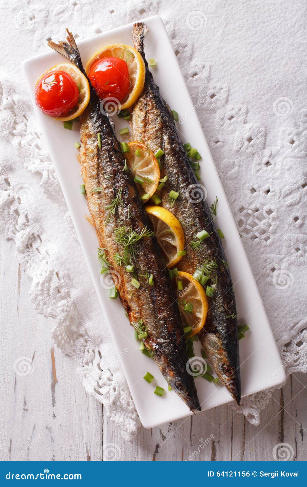 Saury Grilled with Vegetables on a Plate Close-up. Vertical Top Stock ...