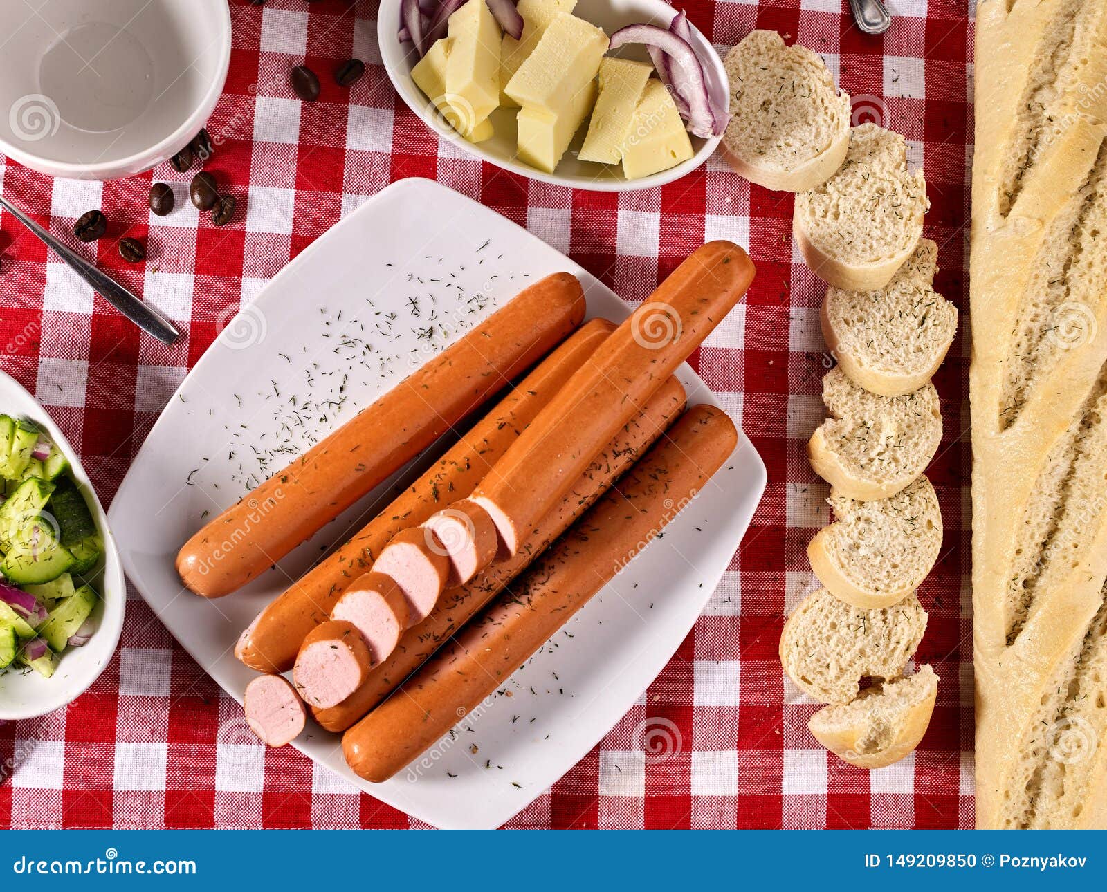Sausage Portion with Baguette on Table Setting on Checkered Cloth Stock ...