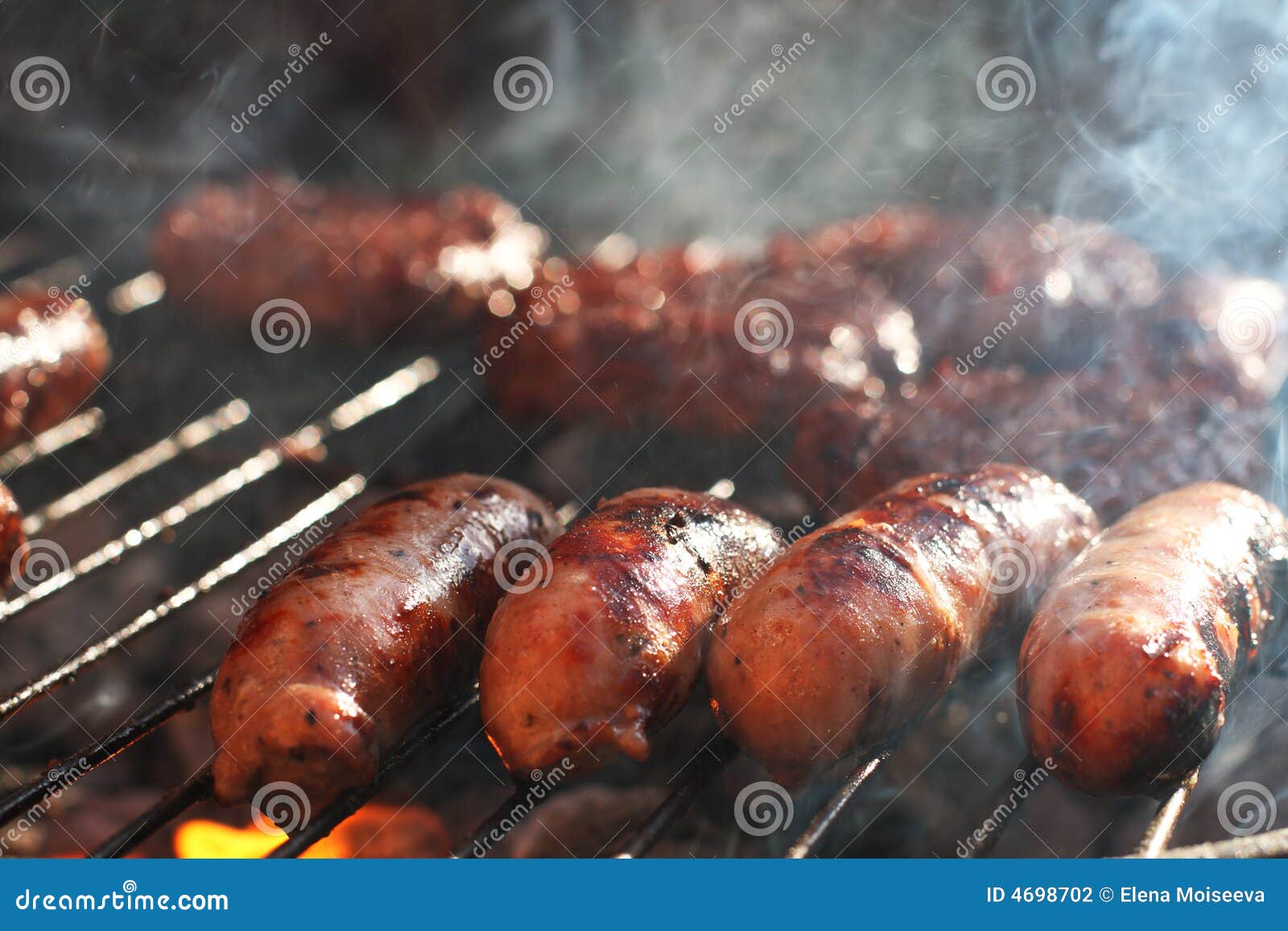 Sausages on Barbecue Grill with Smoke and Flame Stock Photo - Image of ...