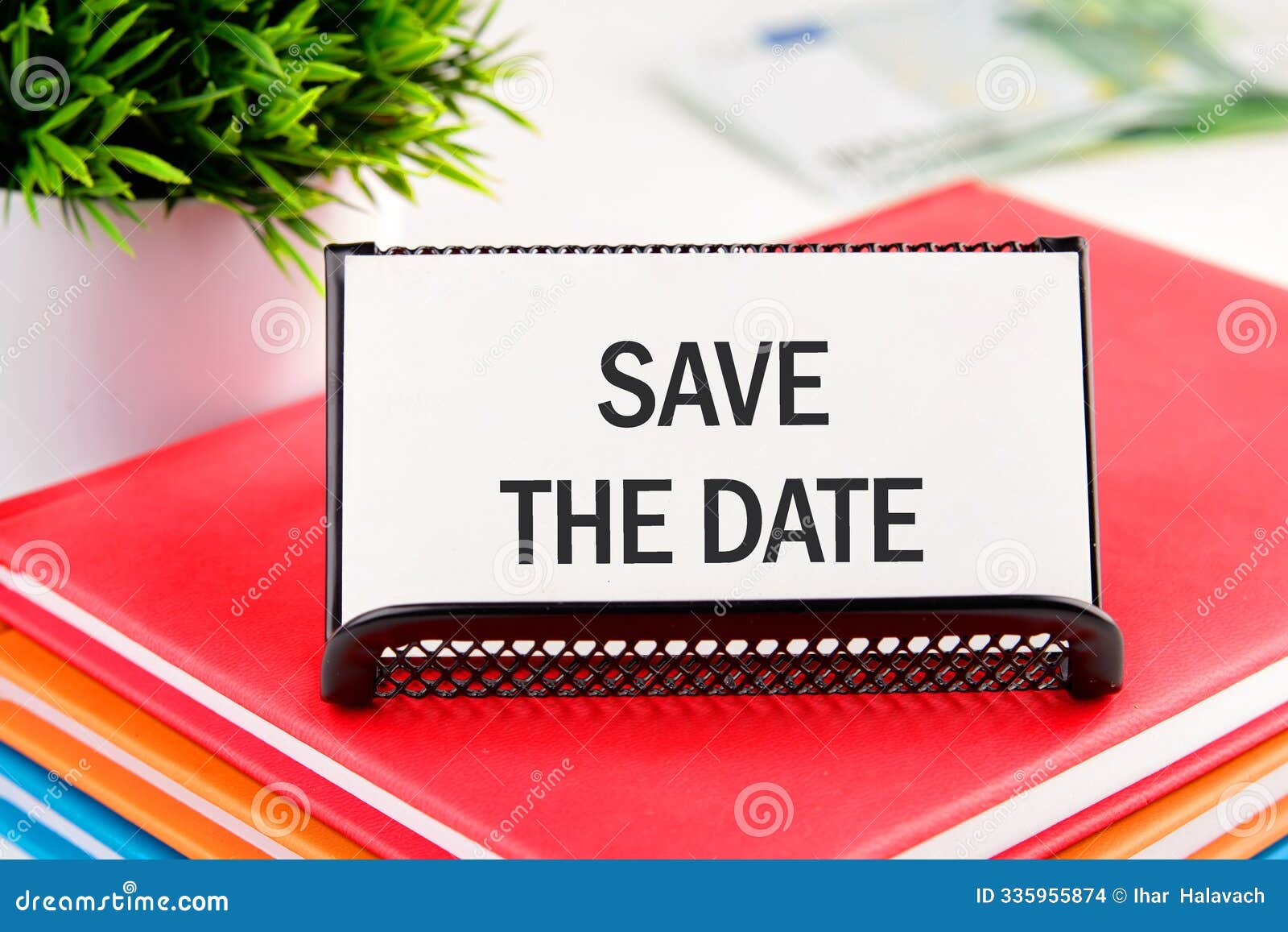 SAVE the DATE Words on a Business Card Standing in a Stand on Notebook ...